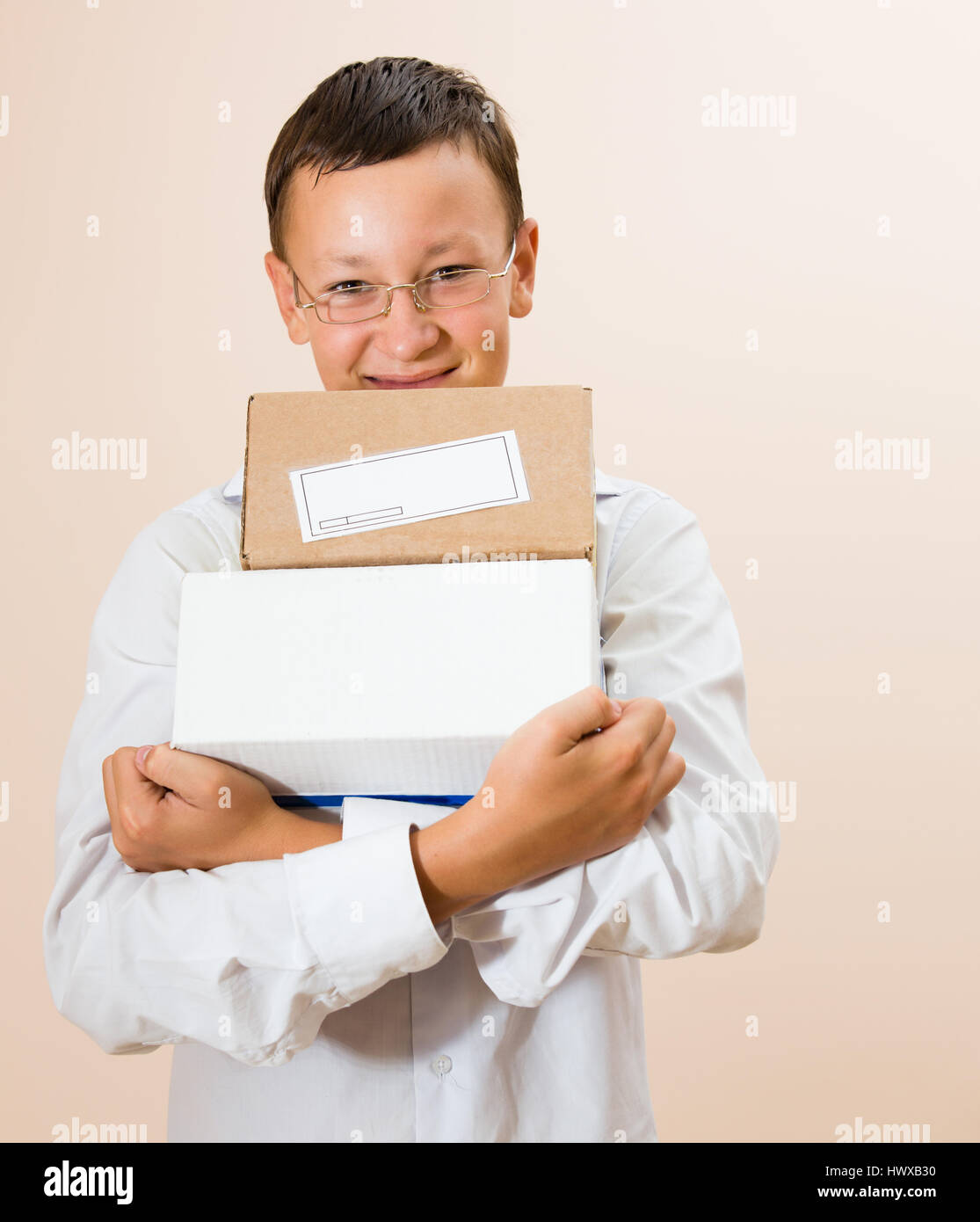 Boy with boxes of parcels in the hands Stock Photo - Alamy