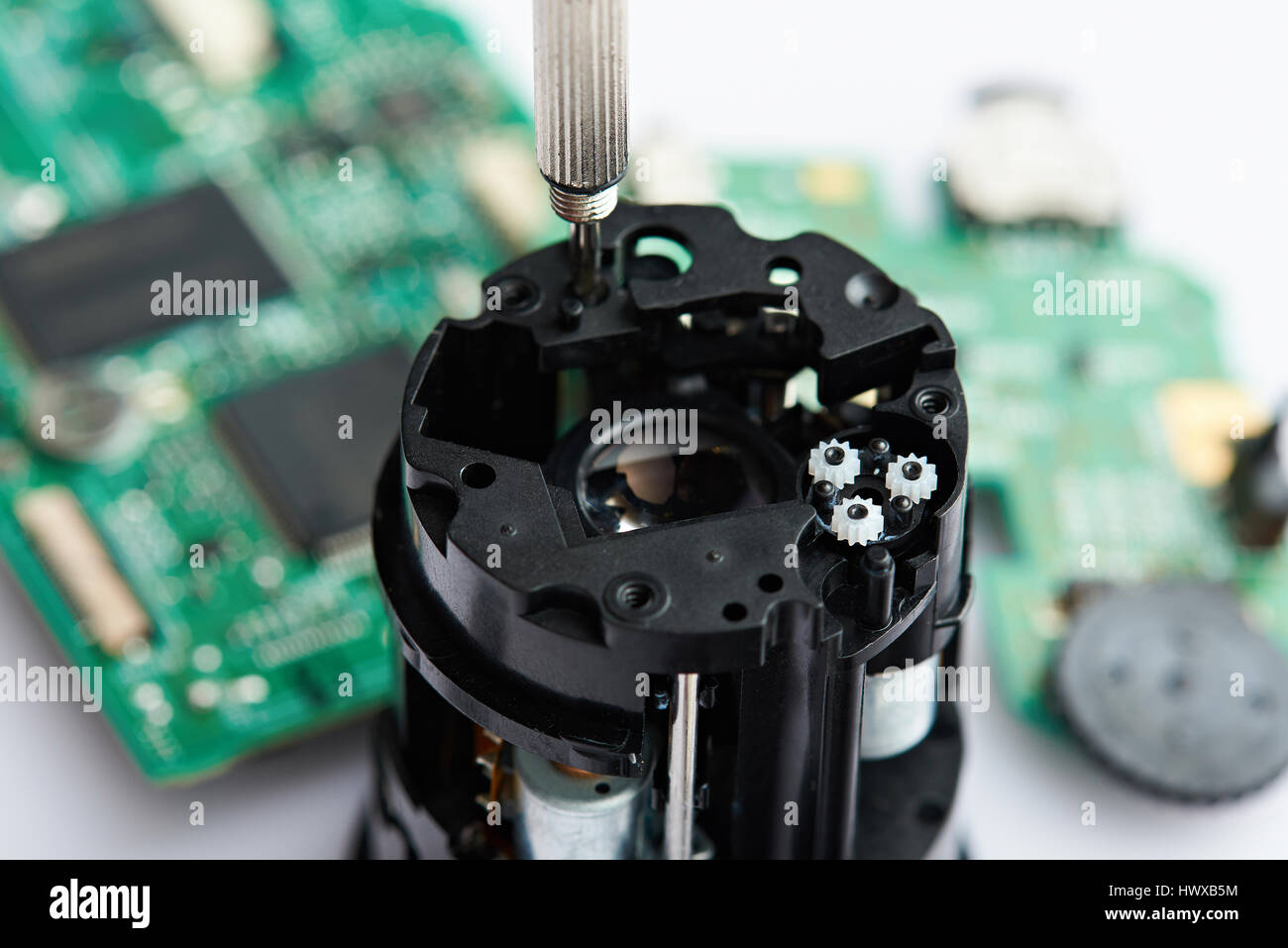 Repairing of DSLR lens on burred motherboard background. Digital camera ...