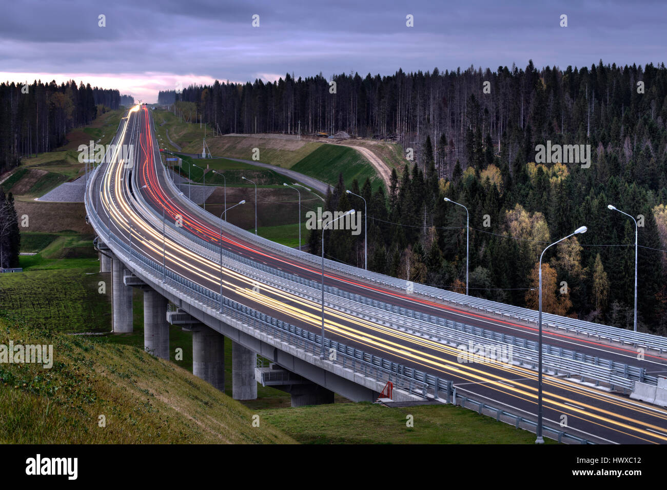 Light trails Freeway in the autumn Russian forest after sunset Stock ...
