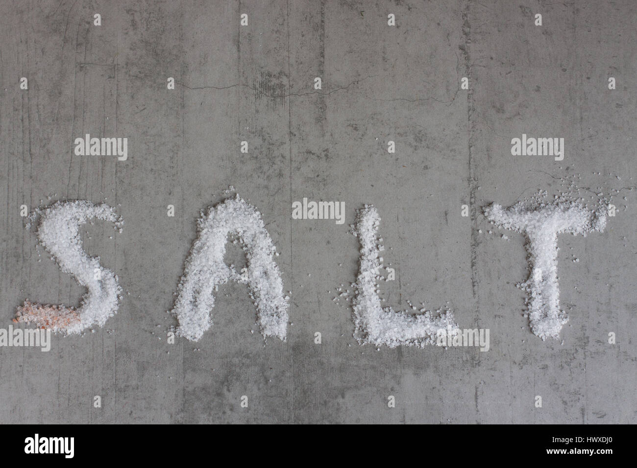 A word "salt" written with real salt on a concrete background Stock ...