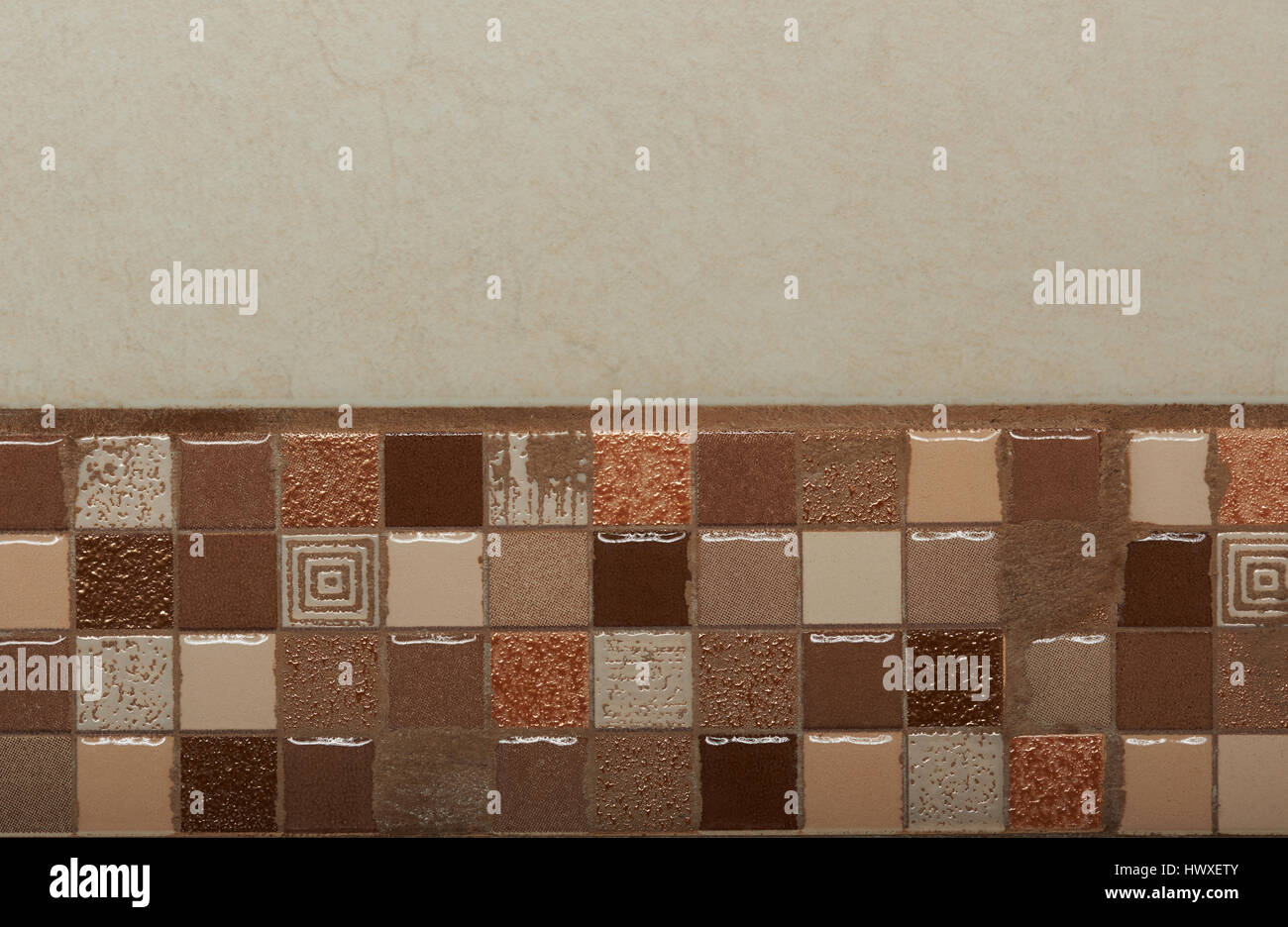 Small brown tiles wall decoration. Ceramic creamy color tiles ...
