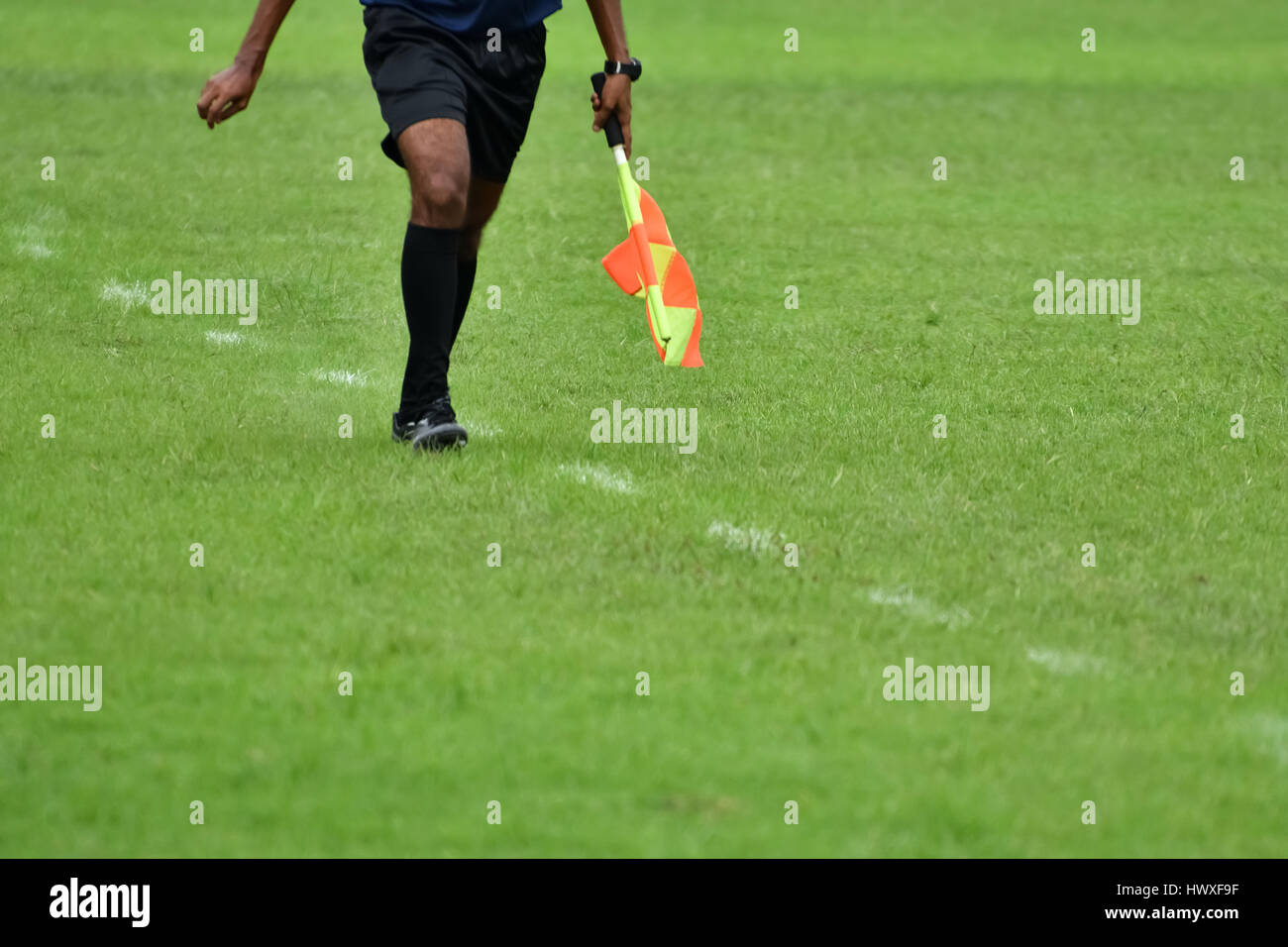 Assistant referee running along the sideline Stock Photo - Alamy