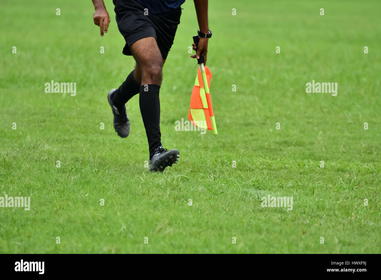 Assistant referee running along the sideline Stock Photo - Alamy