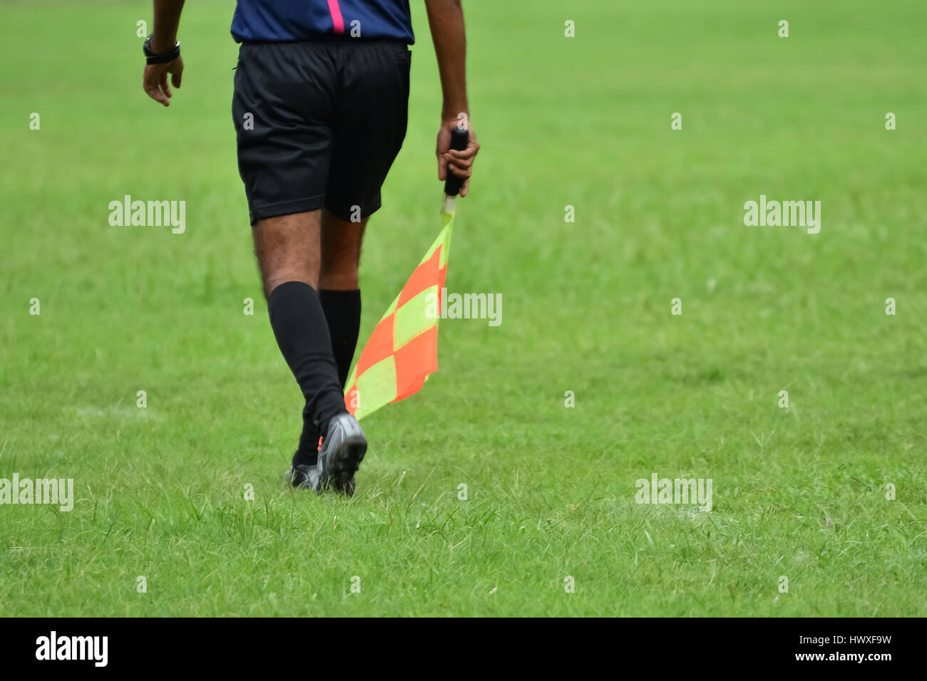 Assistant referee running along the sideline Stock Photo - Alamy