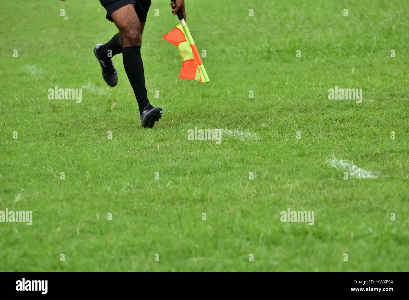 Assistant referee running along the sideline Stock Photo - Alamy