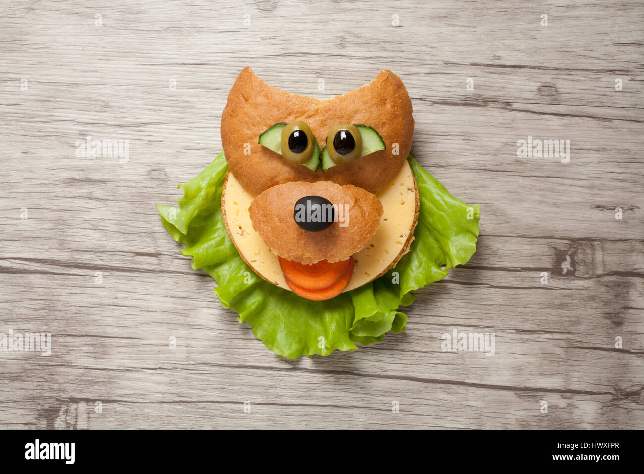 Wolf made of bread and salad on wooden background Stock Photo - Alamy