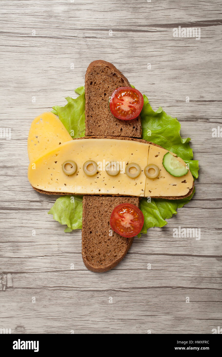 Amusing sandwich plane made on wooden table Stock Photo - Alamy