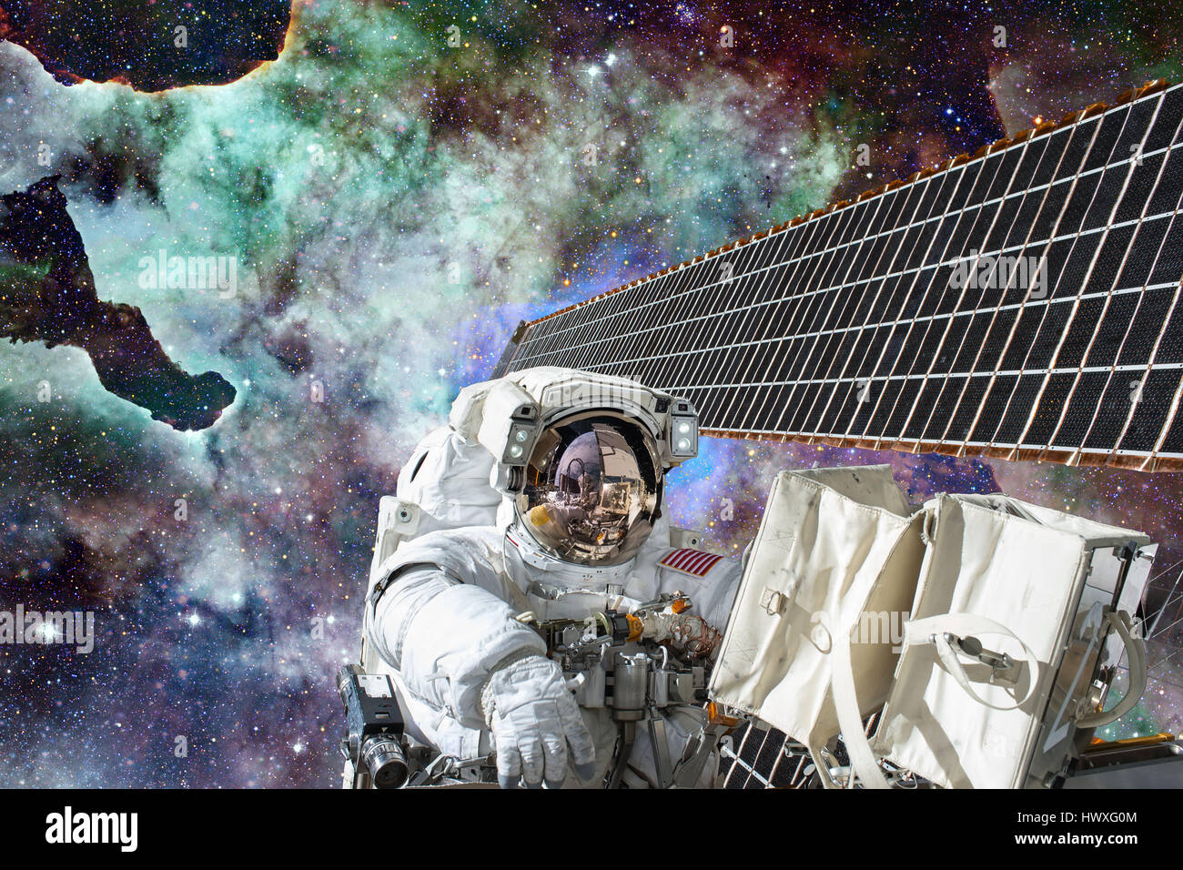 Cosmonaut works outside the International Space Station. Elements of ...