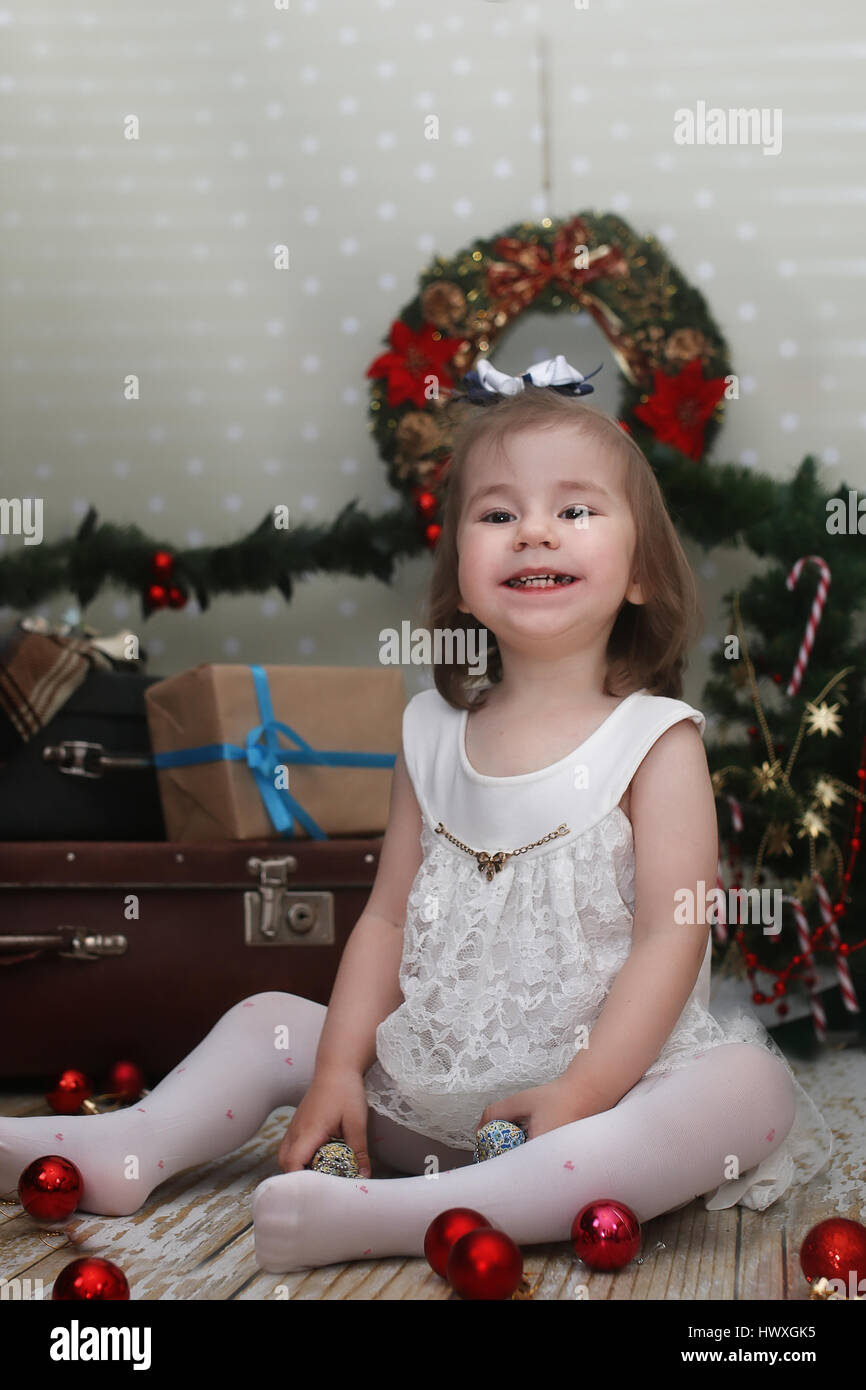 cute little girl dresses up Christmas tree Stock Photo - Alamy