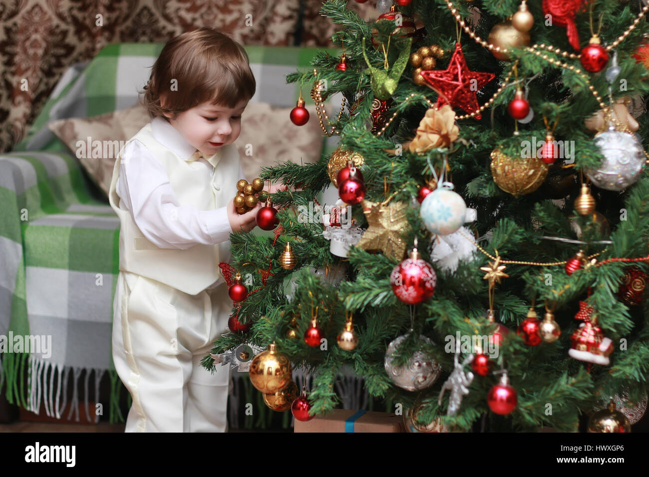 child decorate the Christmas tree toy Stock Photo - Alamy