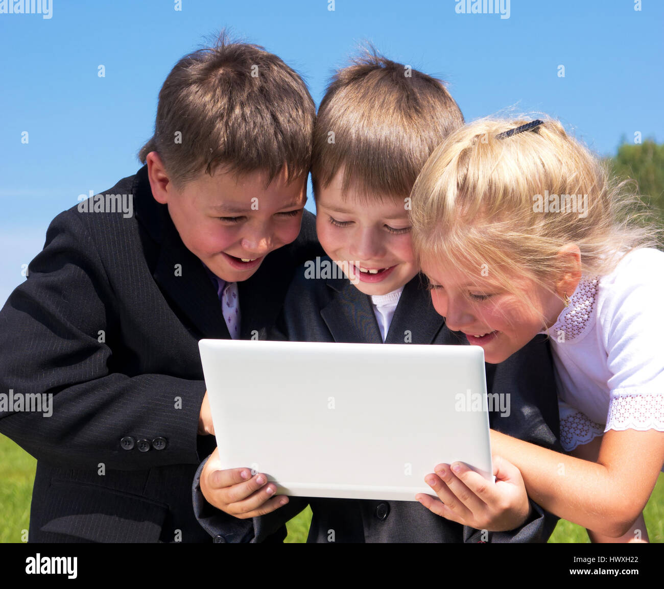 three friends with laptop computer Stock Photo - Alamy