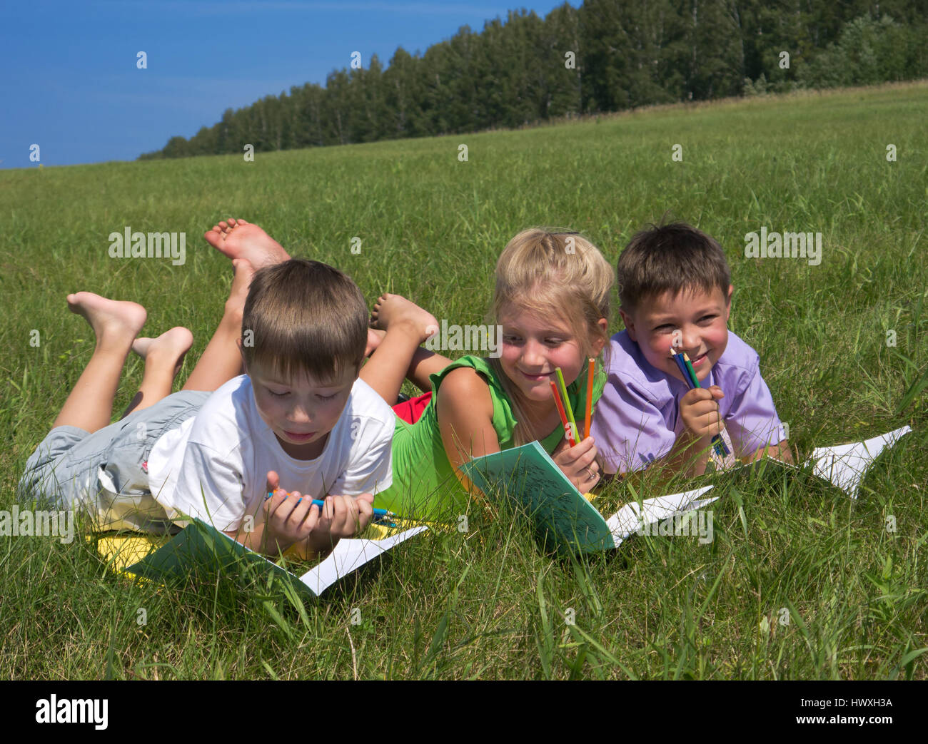 Portrait happy schoolkids sitting hi-res stock photography and images ...