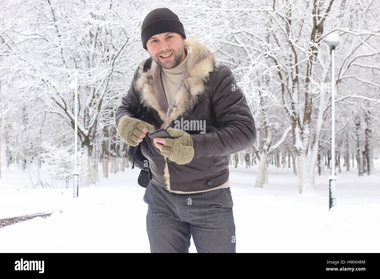 bearded man walking in a winter park Stock Photo - Alamy