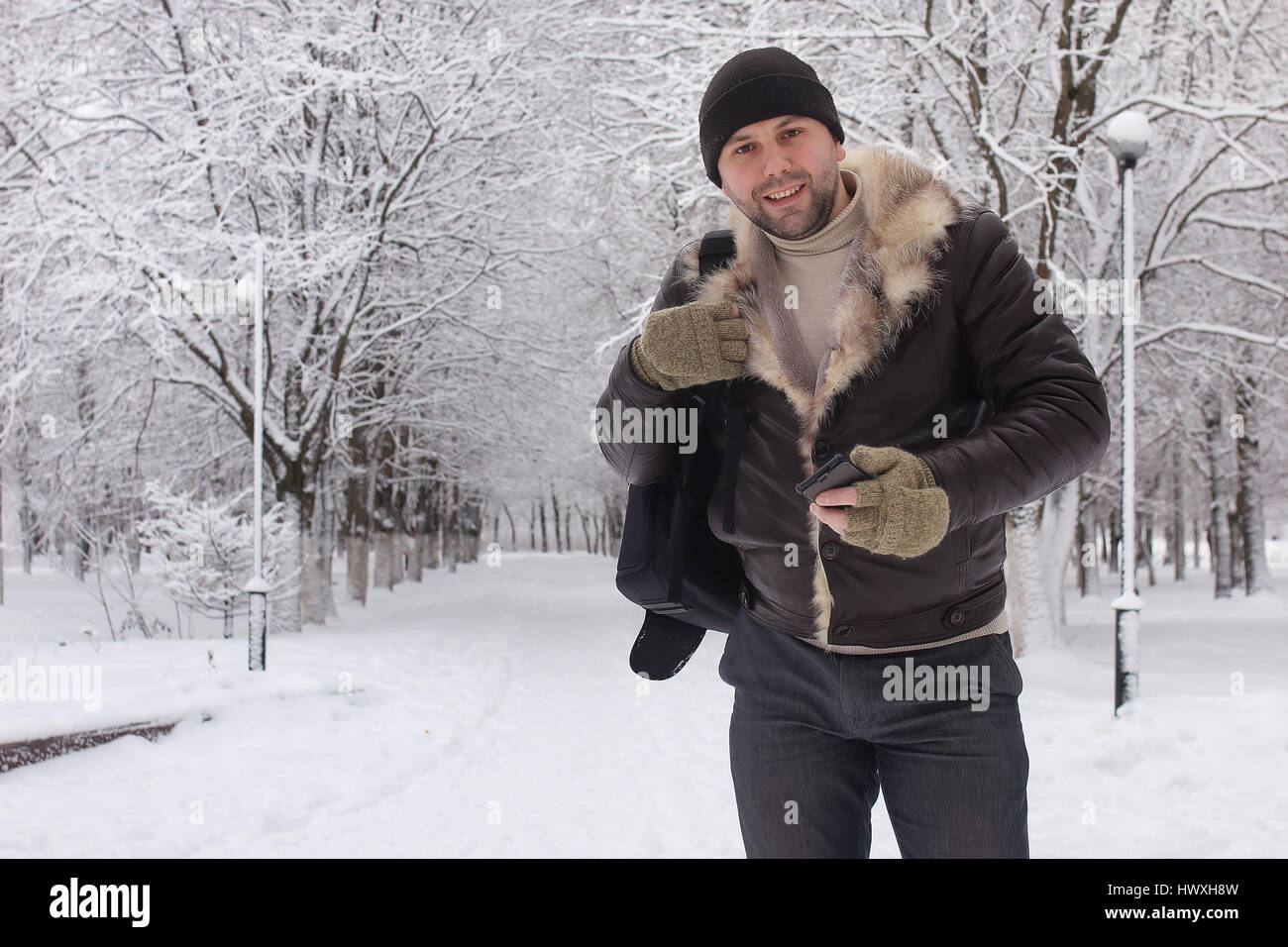 bearded man walking in a winter park Stock Photo - Alamy
