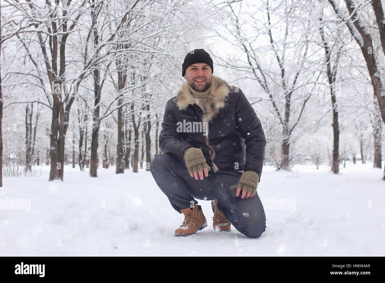 bearded man walking in a winter park Stock Photo - Alamy