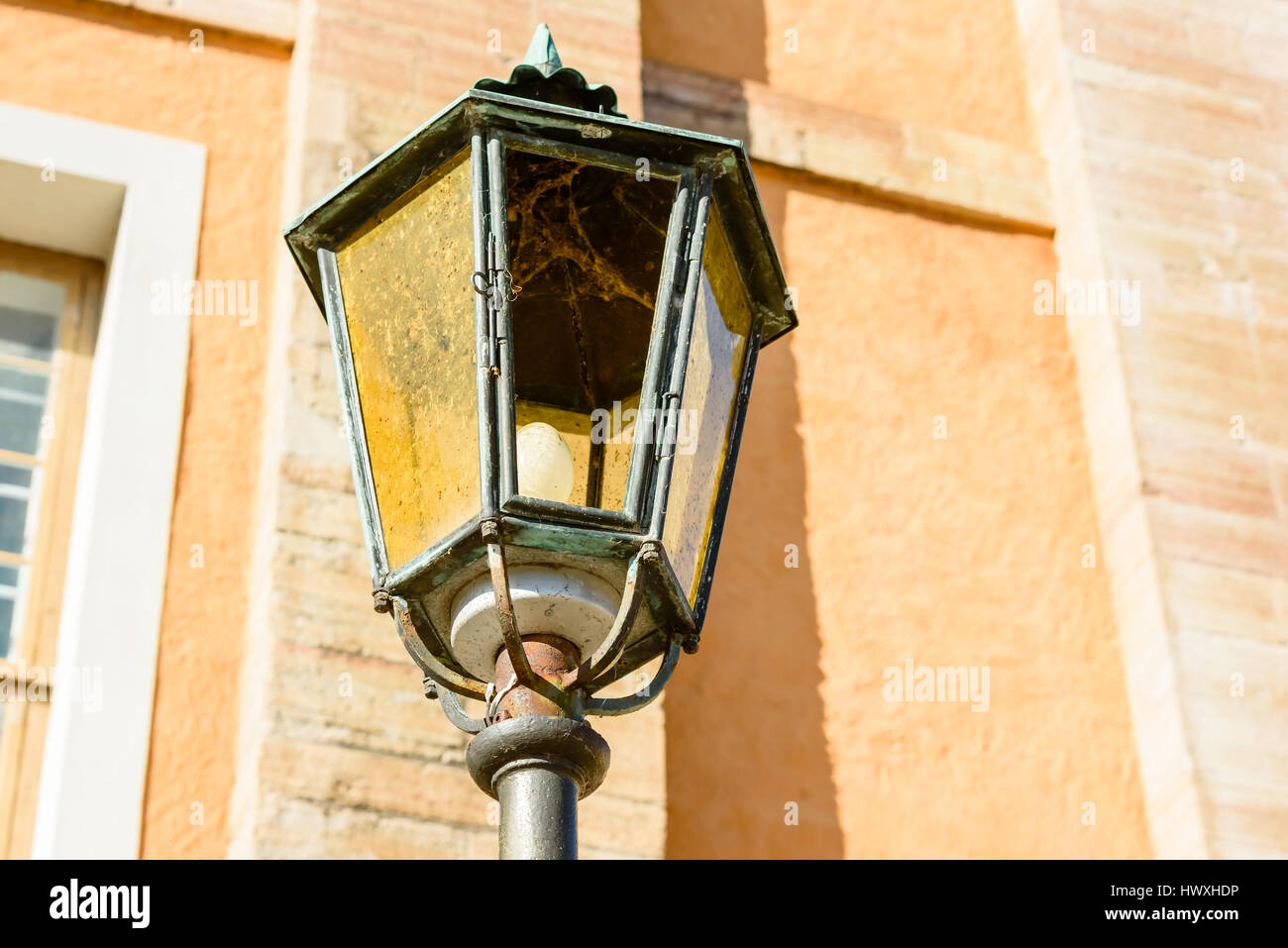 Old and broken lamppost outside a building Stock Photo - Alamy