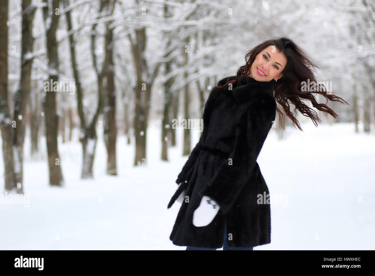 woman walking in winter snow-covered park Stock Photo - Alamy