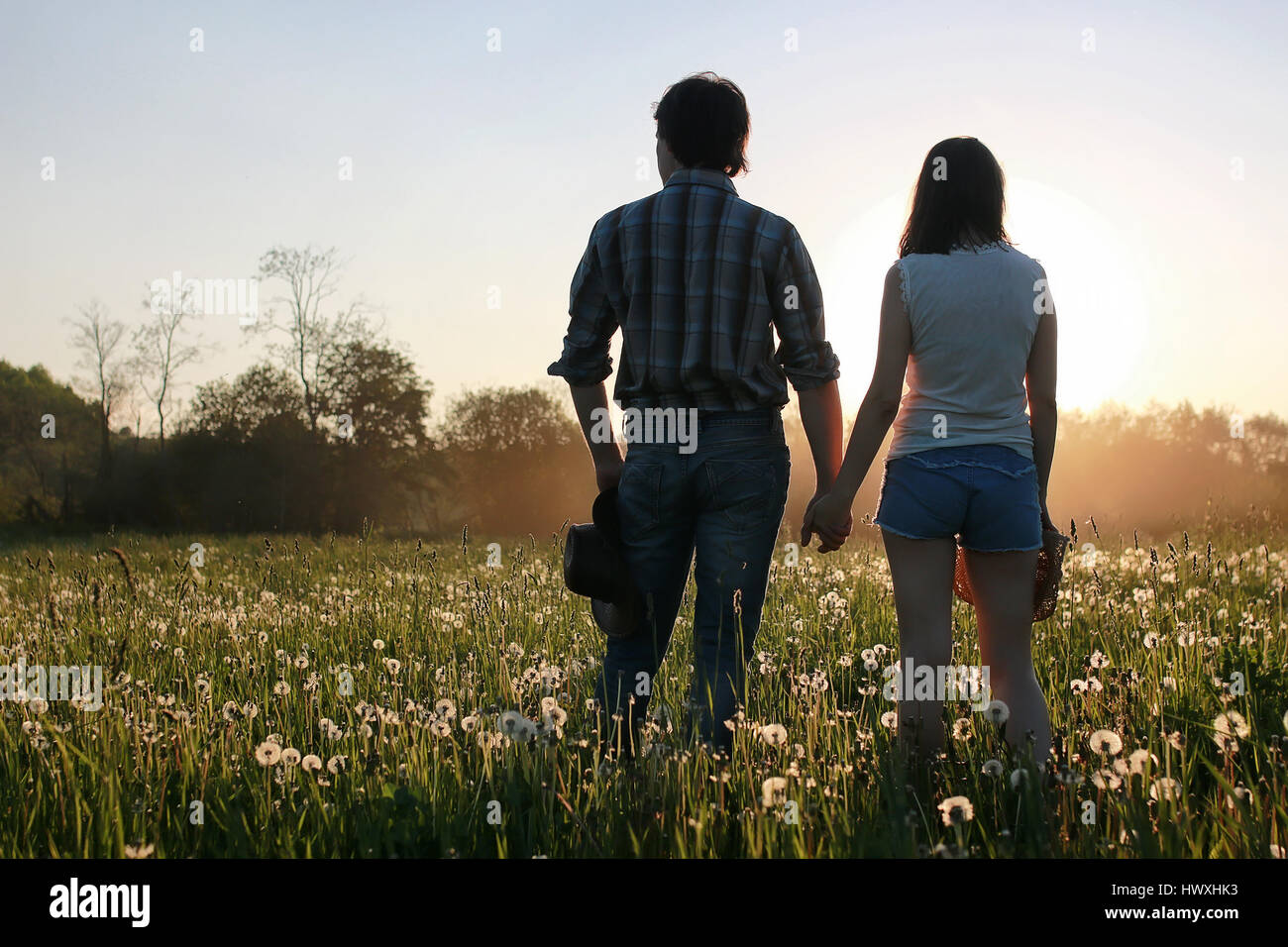 couple of young people walking in the sunset spring evening in a Stock ...