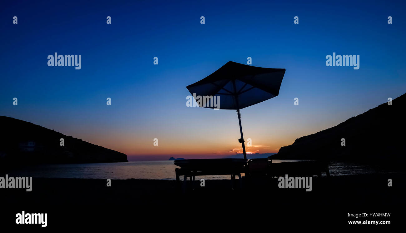 clear blue sky with umbrella at night on the beach of Crete Greece ...