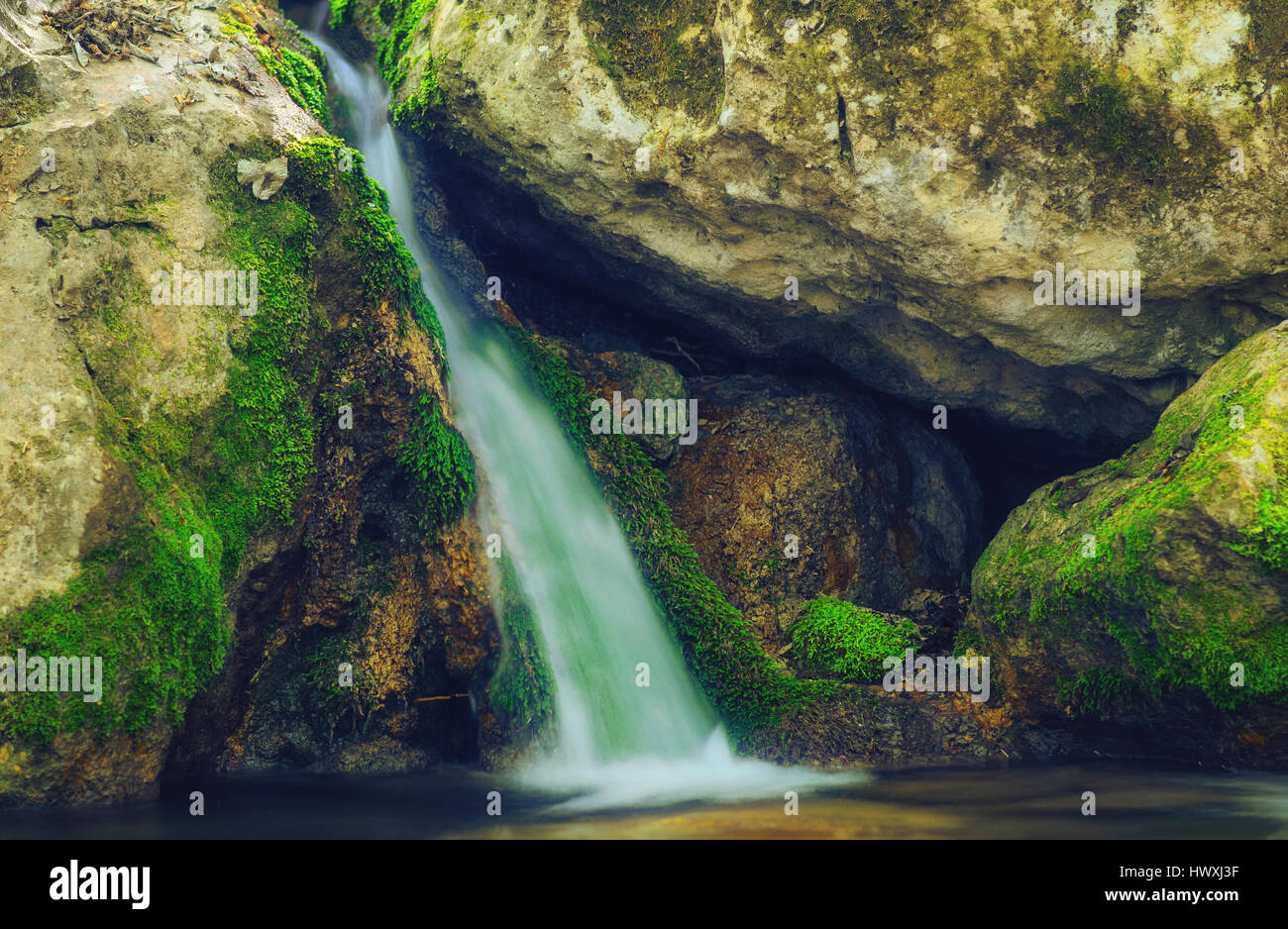 Mountain creek on the stones cascades with pure water. Spring landscape ...