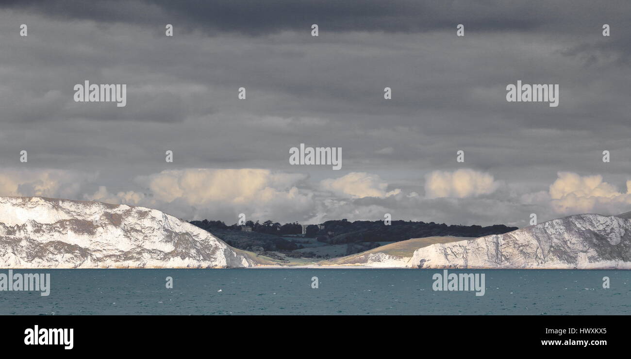 Lulworth Castle across Arish Mell beach flanked by eroded white cliffs ...