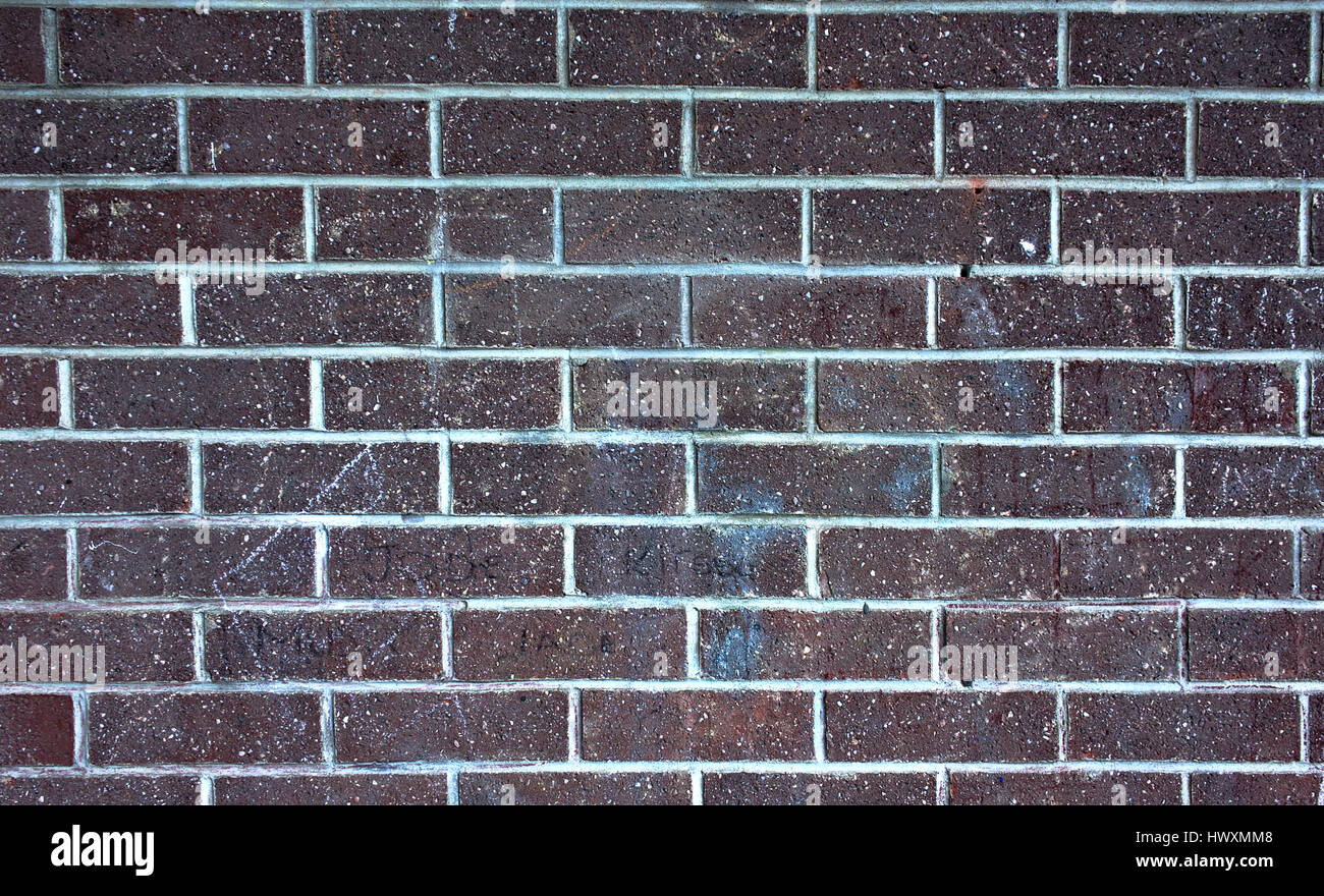 Brown brick wall on council estate. Background texture with copy space ...