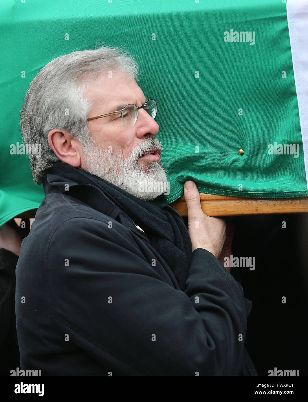 Gerry Adams carries the coffin during the funeral procession of ...