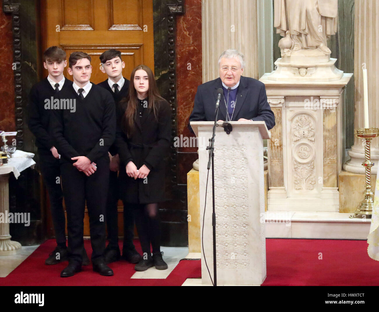 Rev Harold Good speaks while Martin McGuinness' grandchildren look on ...