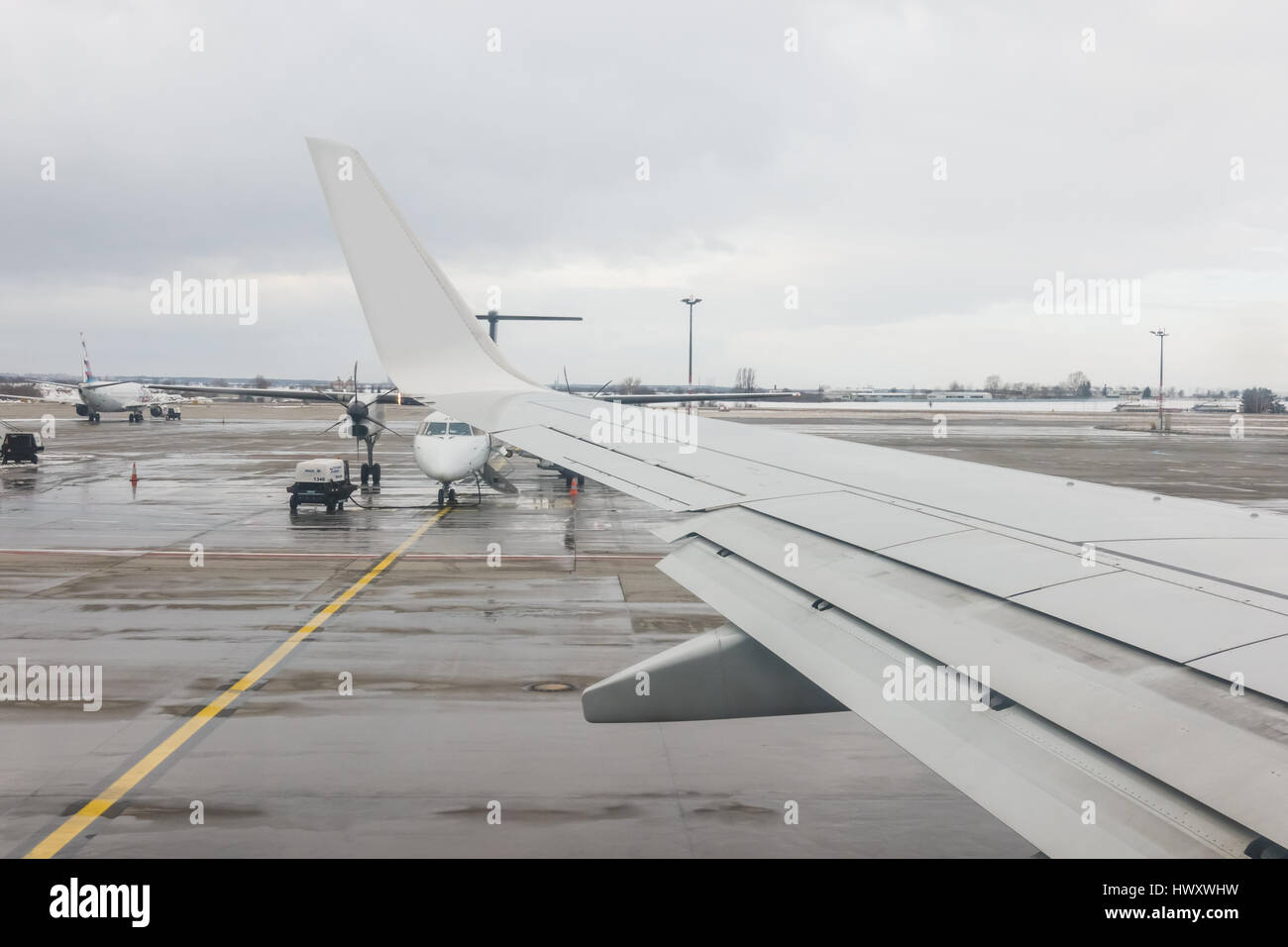 View of an airport and wing of an aircraft Stock Photo - Alamy