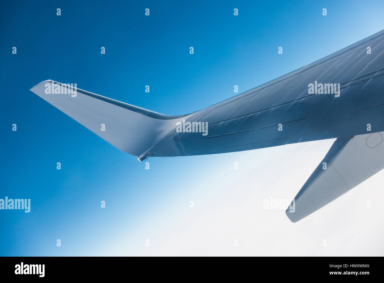 Wing of an aircraft and blue sky Stock Photo - Alamy