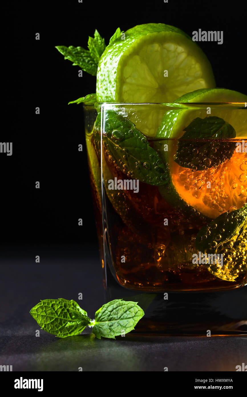 Cola with lime , ice and peppermint on black table Stock Photo - Alamy