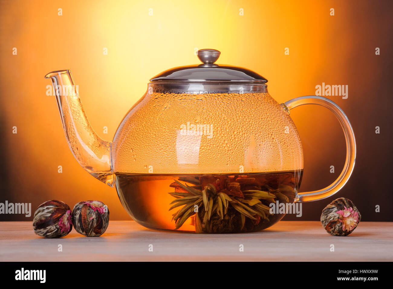A glass teapot with Lotus Flower Chinese tea on wooden background Stock ...