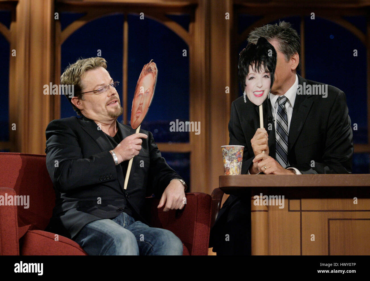 Eddie Izzard, left, with a mask of himself chats with host Craig ...