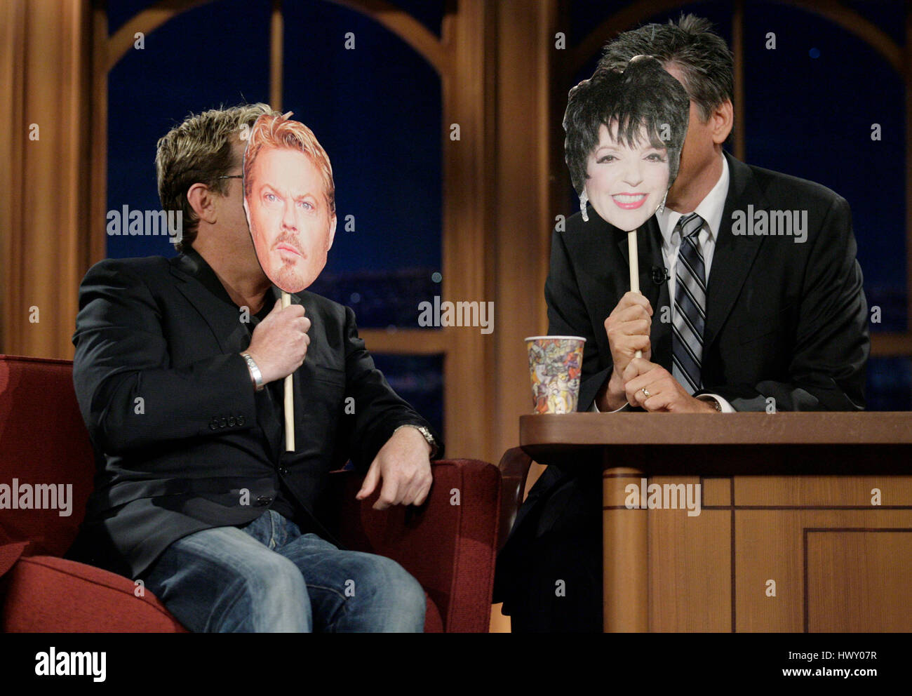 Eddie Izzard, left, with a mask of himself chats with host Craig ...