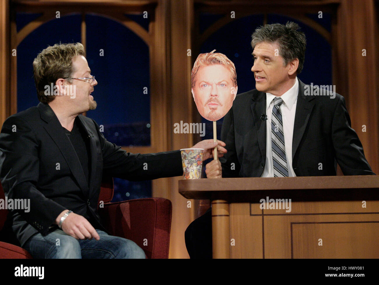 Eddie Izzard, left, chats with host Craig Ferguson with a mask of ...