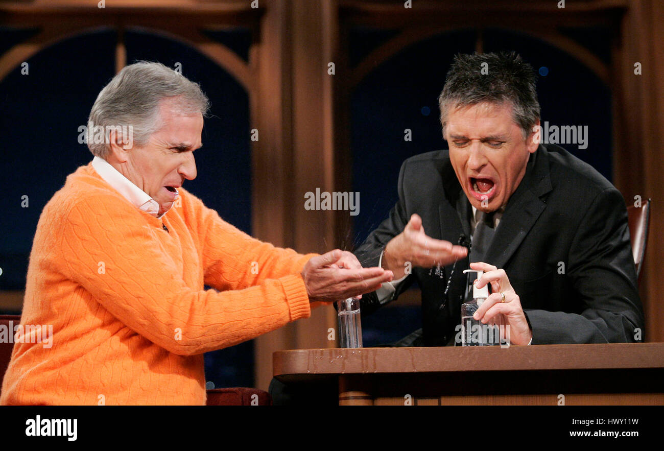 Henry Winkler, left, and host Craig Ferguson use hand sanitizer to ...
