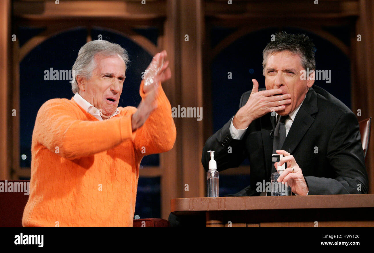 Henry Winkler, left, and host Craig Ferguson use hand sanitizer to ...