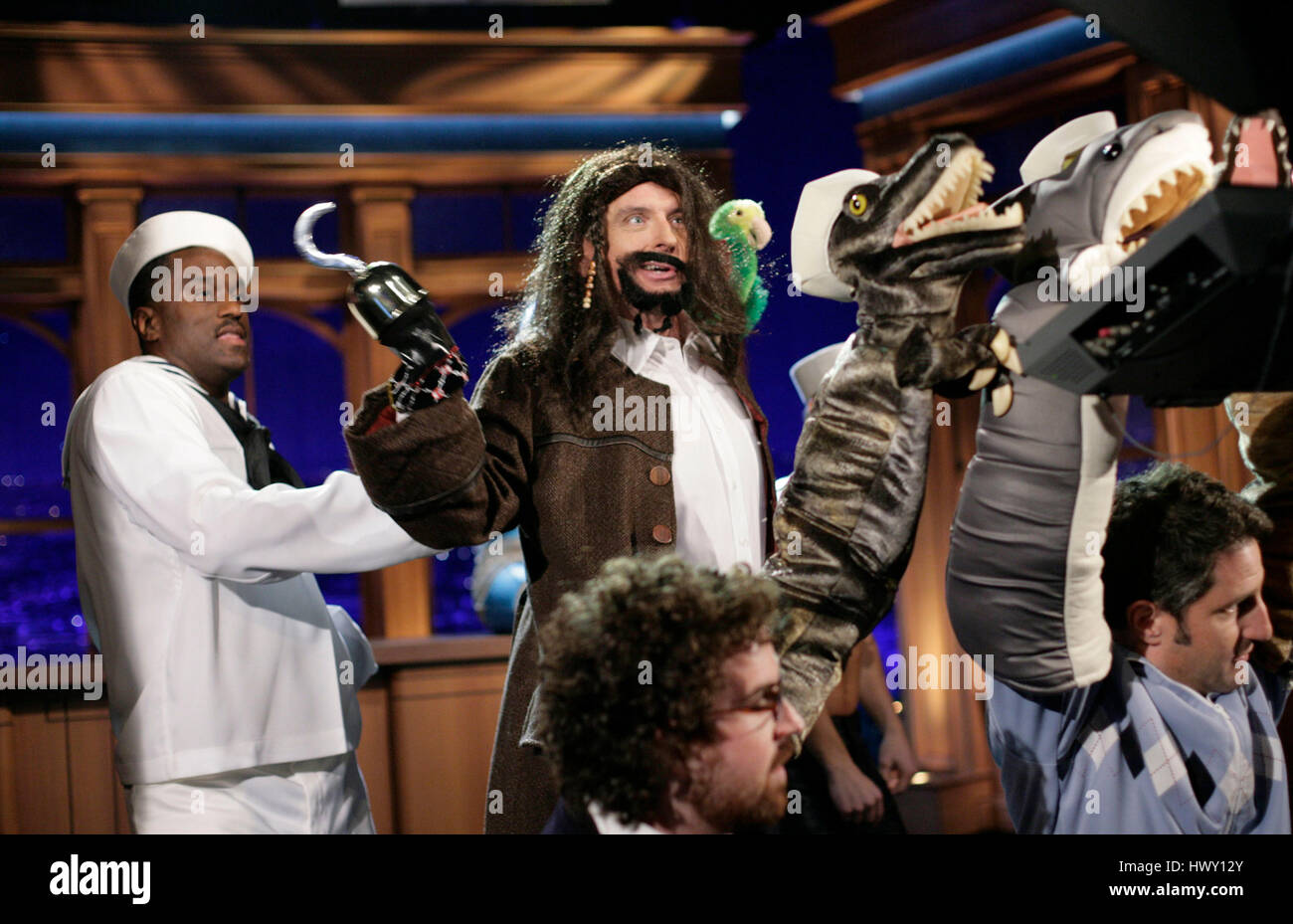 Host Craig Ferguson, center, wears a pirate costume and sings with ...