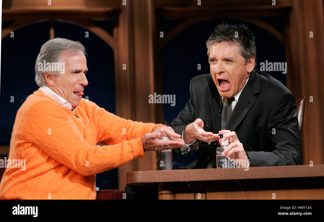 Henry Winkler, left, and host Craig Ferguson use hand sanitizer to ...