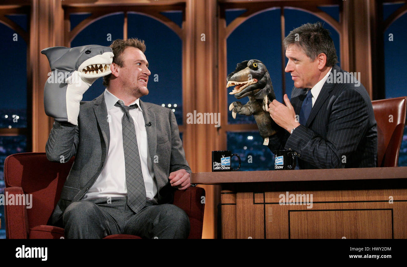 Actor Jason Segel, left, and host Craig Ferguson play with puppets ...