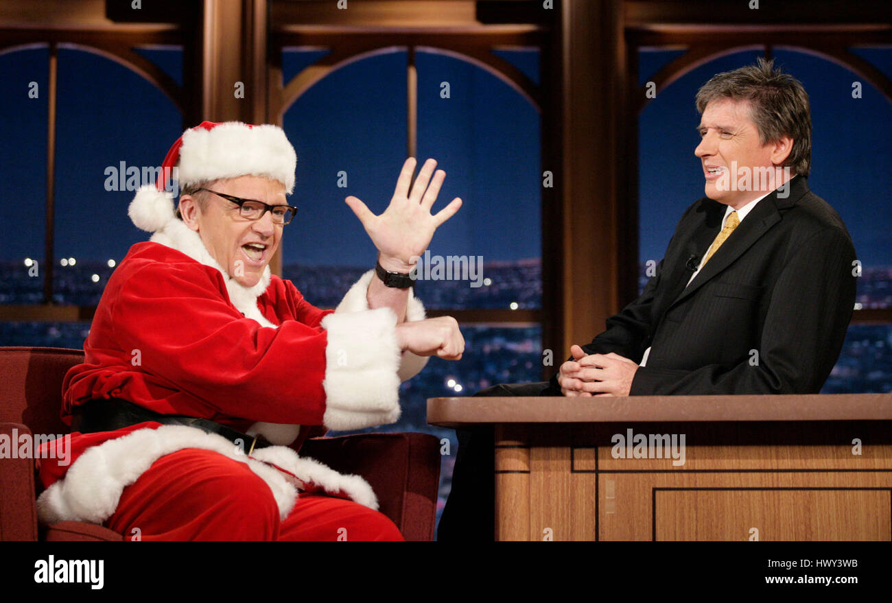 Actor Tom Arnold in a Santa Claus suit, left, chats with host Craig ...