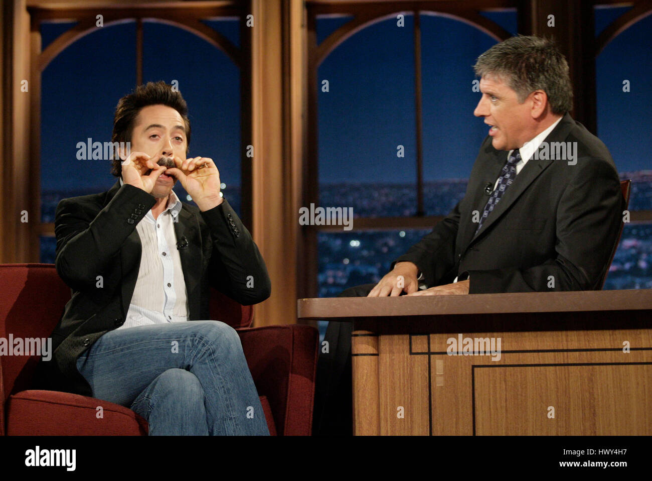 Actor Robert Downey Jr., left, plays with his mustache as host Craig ...
