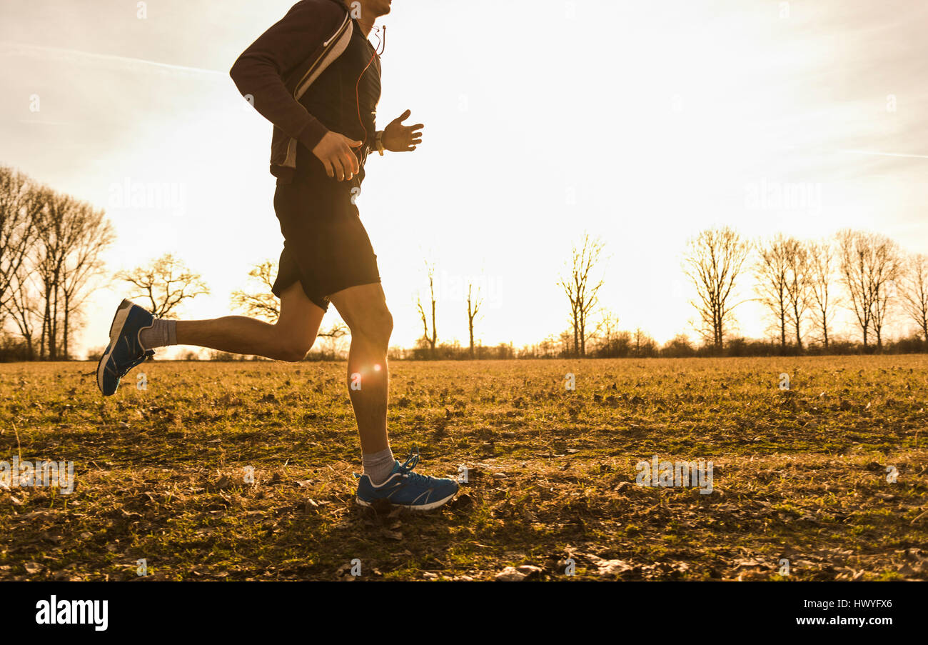Man running in rural landscape Stock Photo - Alamy