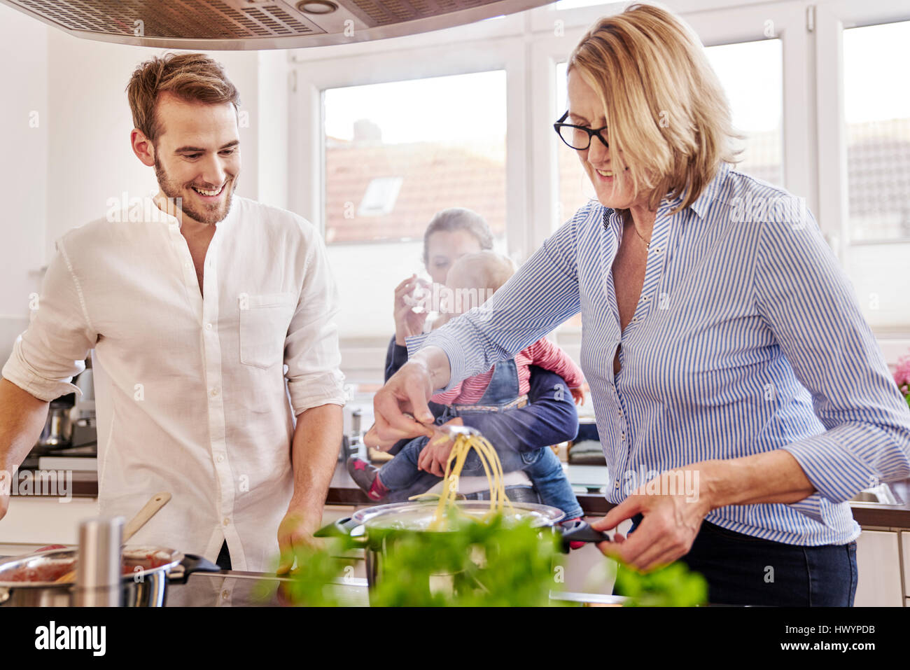 Family cooking in kitchen Stock Photo - Alamy
