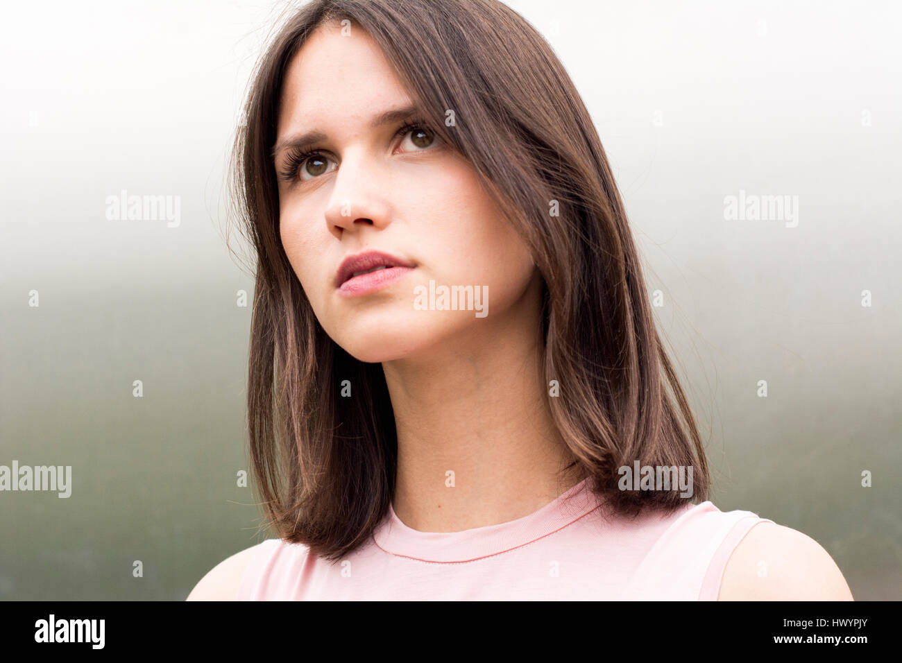 Portrait of young woman watching something Stock Photo - Alamy
