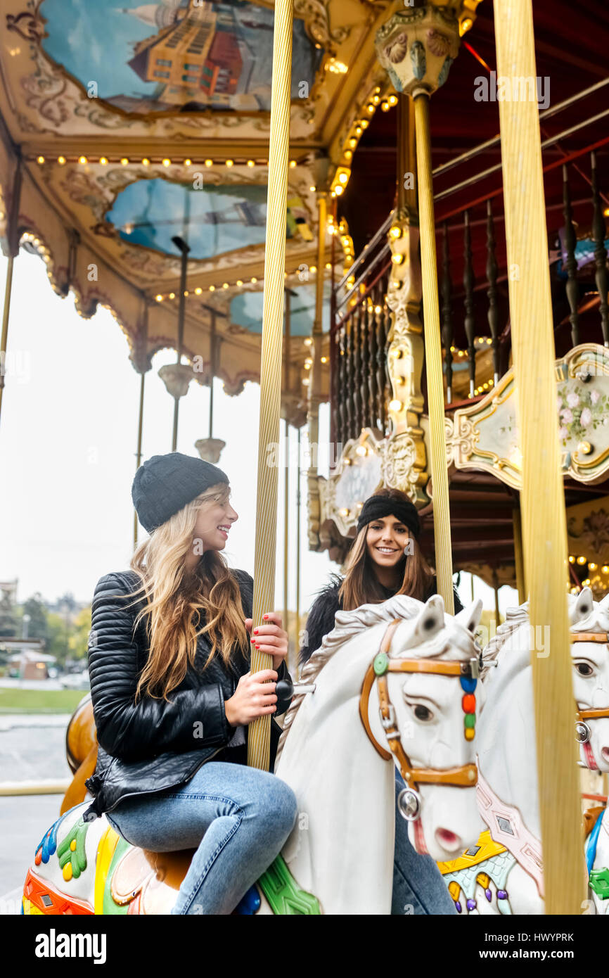 Two best friends riding a carousel hi-res stock photography and images ...