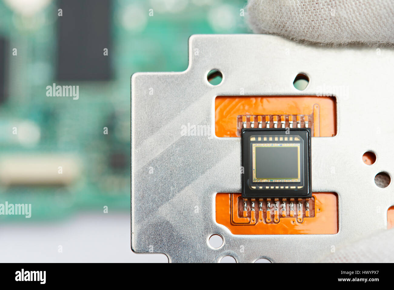 Small digital camera sensor in sciencer hand on electronic circuit ...