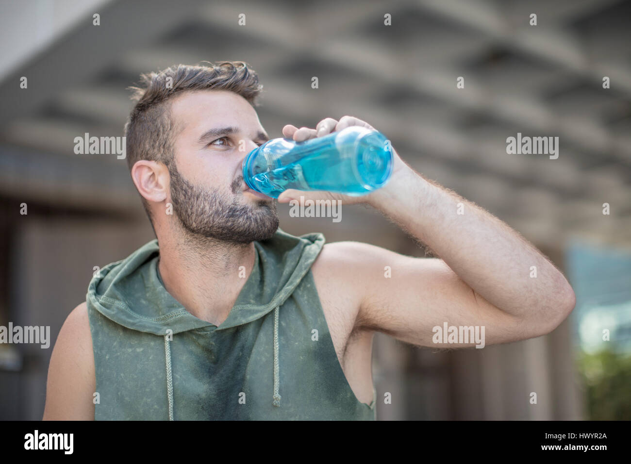 Athlete taking a break in the city drinking water from bottle Stock ...