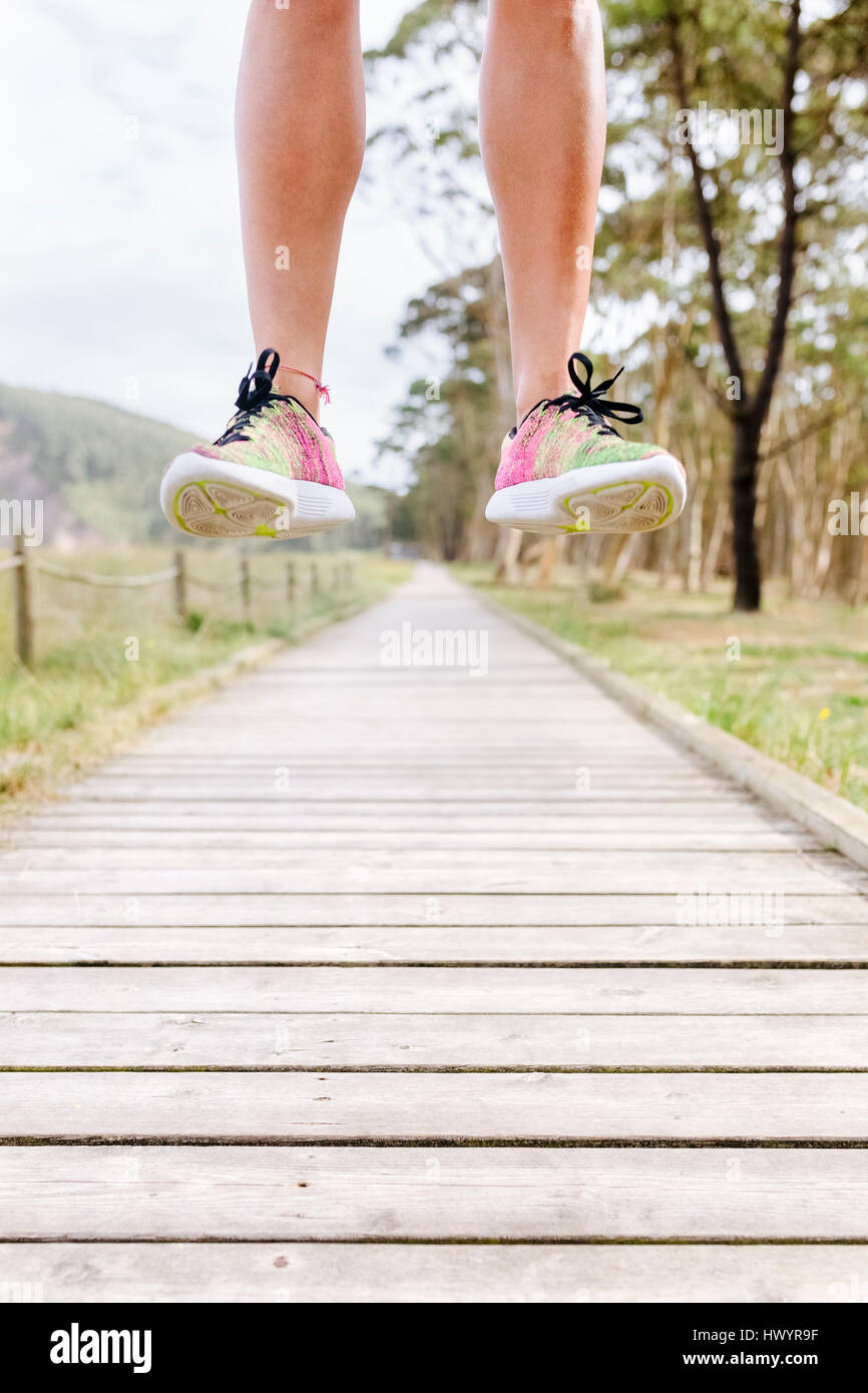 Legs of an athlete jumping on boardwalk Stock Photo - Alamy