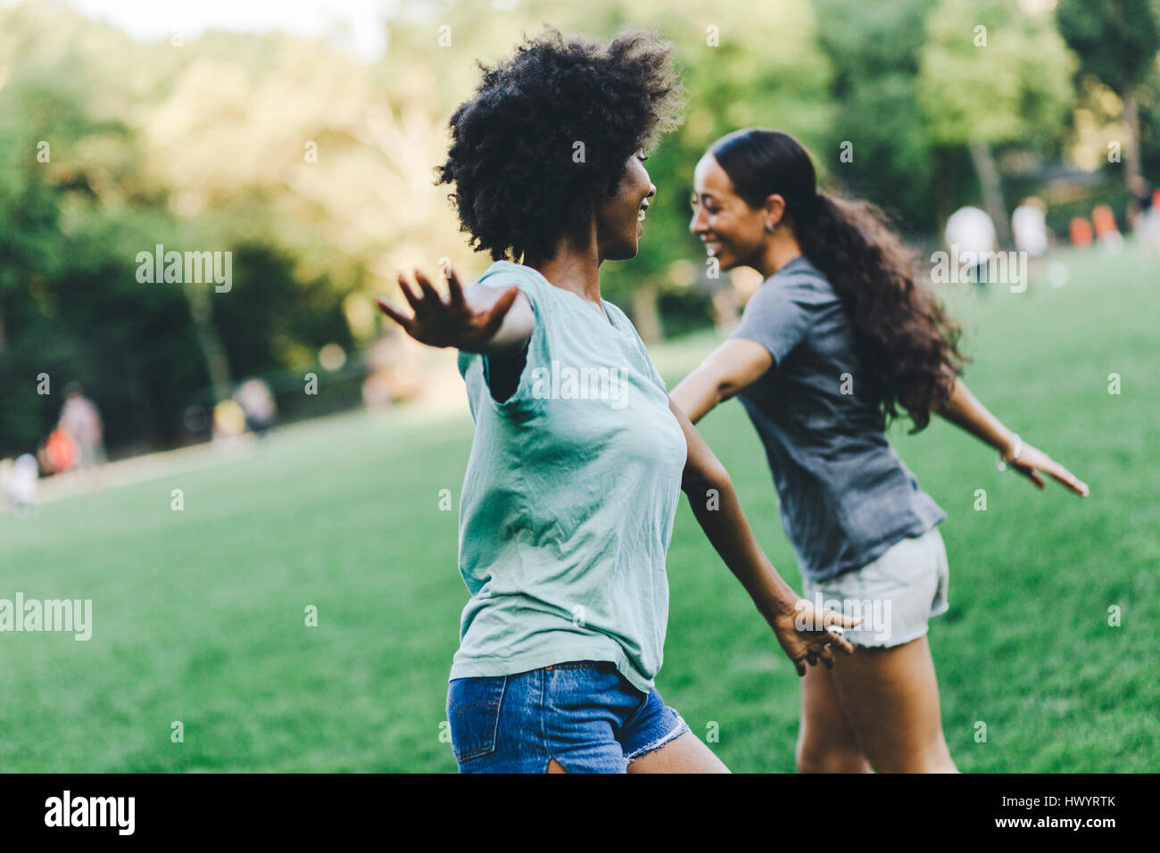 Two best friends having fun together in the park at evening Stock Photo ...